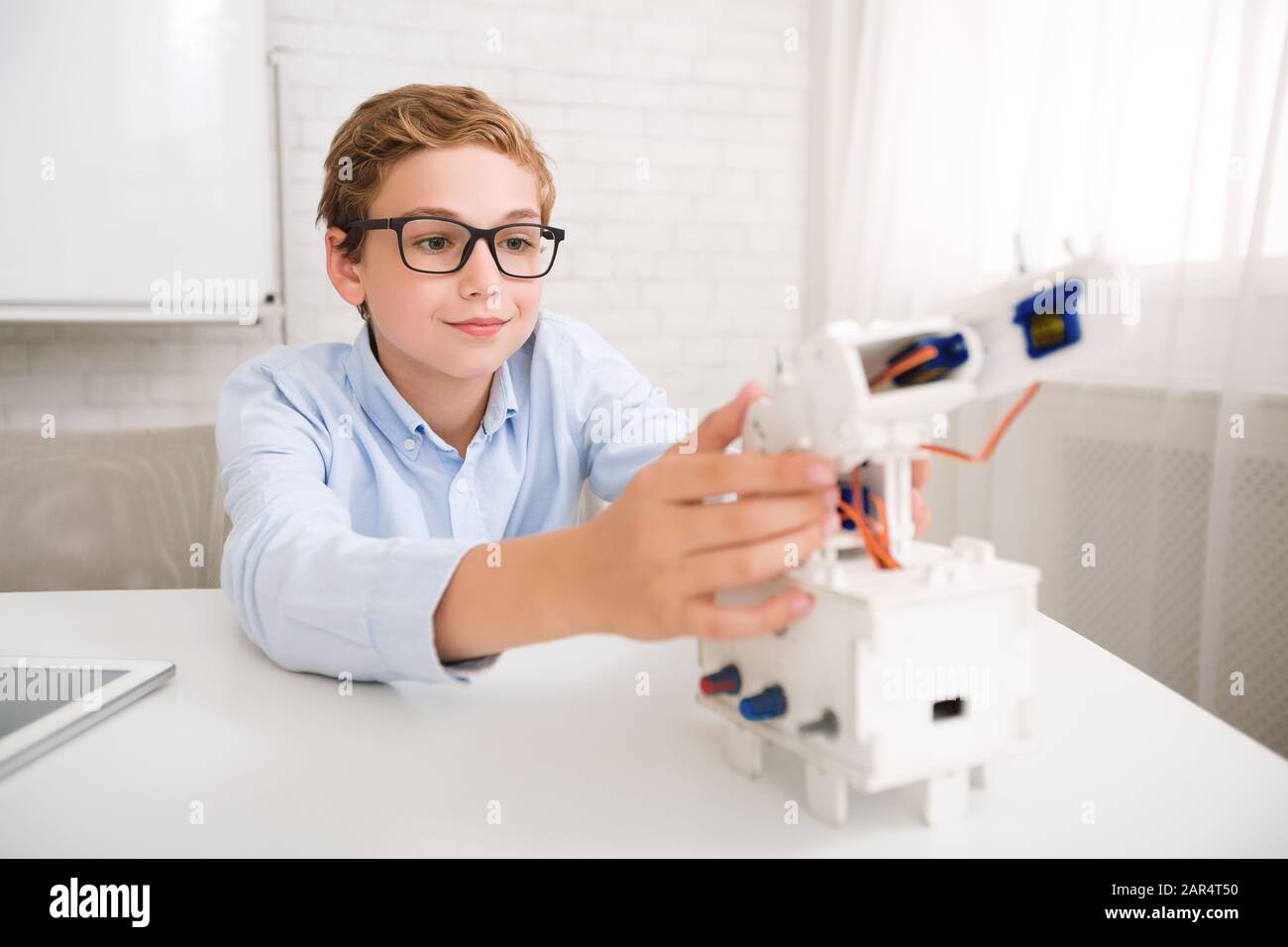 Clever schoolboy constructing robot at stem educational class Stock ...
