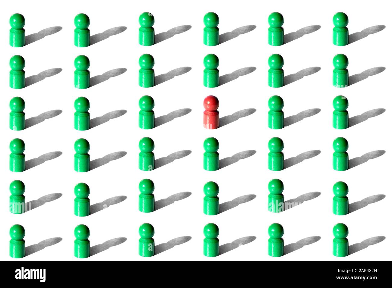 Single red token between green tokens Stock Photo - Alamy