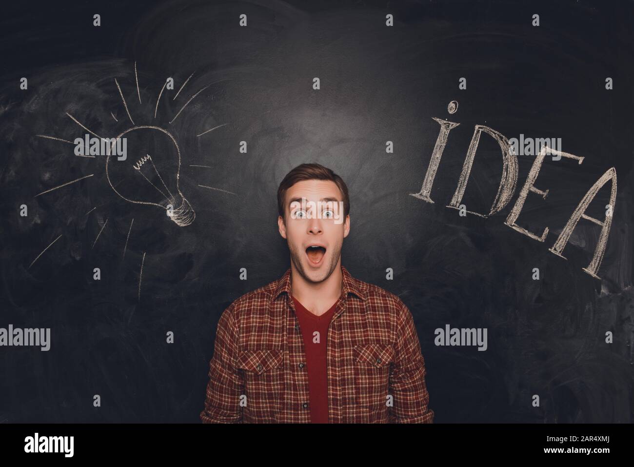 Pleasantly surprised young happy student having an idea Stock Photo - Alamy