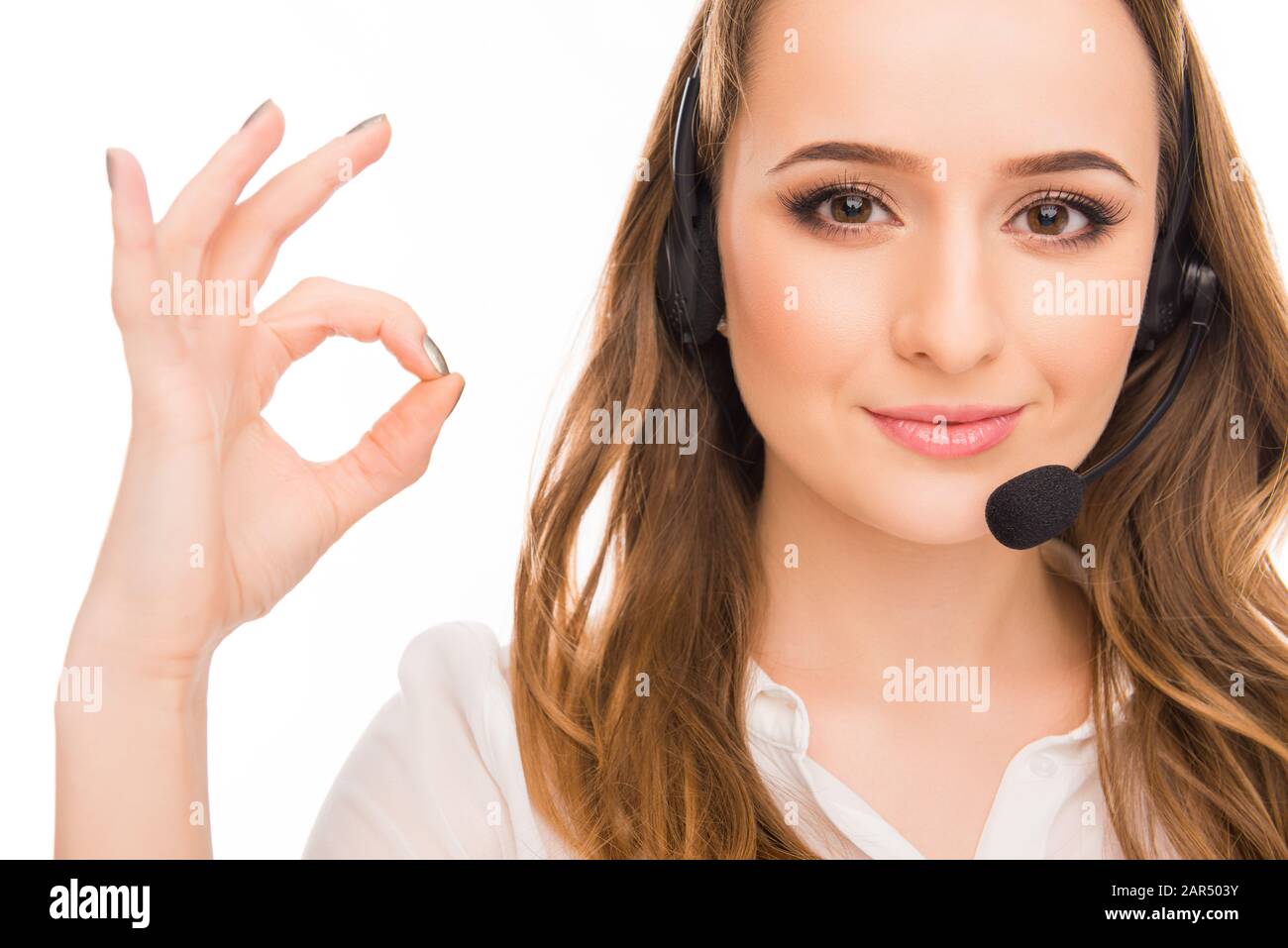 Pretty young agent of call centre gesturing "OK Stock Photo - Alamy