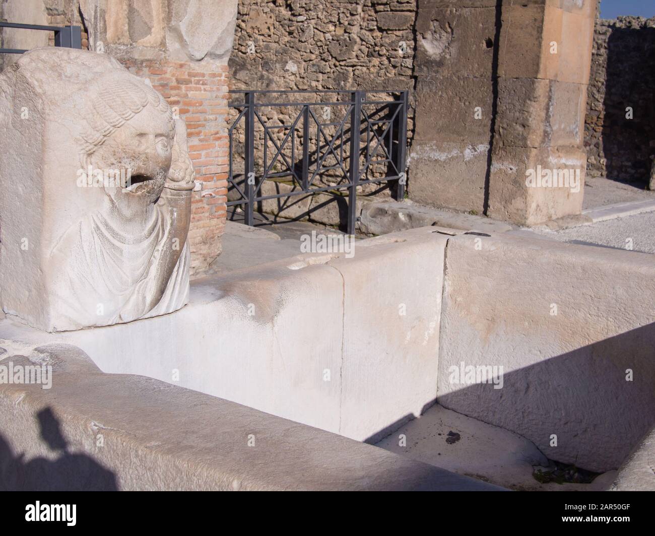 The remain of a marble fountain of ancient Pompeii in Pompei, Italy ...