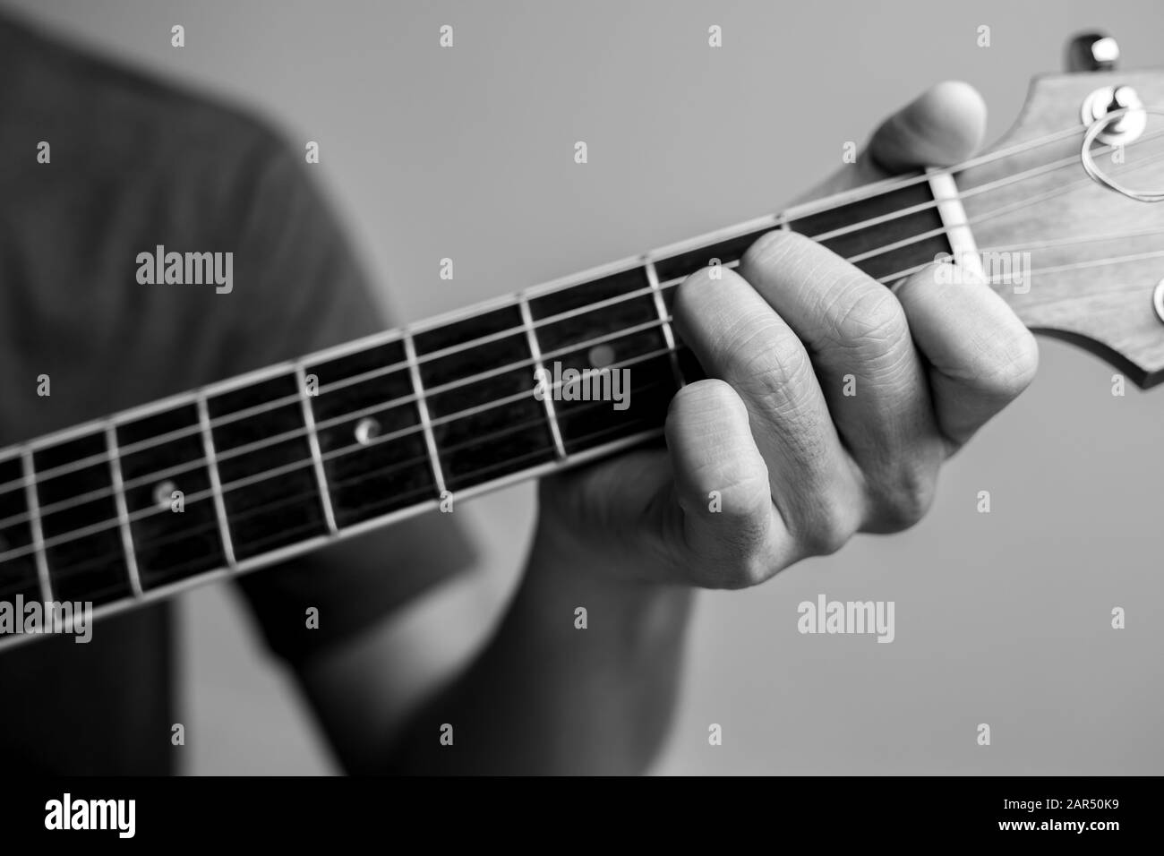Men catch chords are learning to play guitar. Closeup musicians are ...