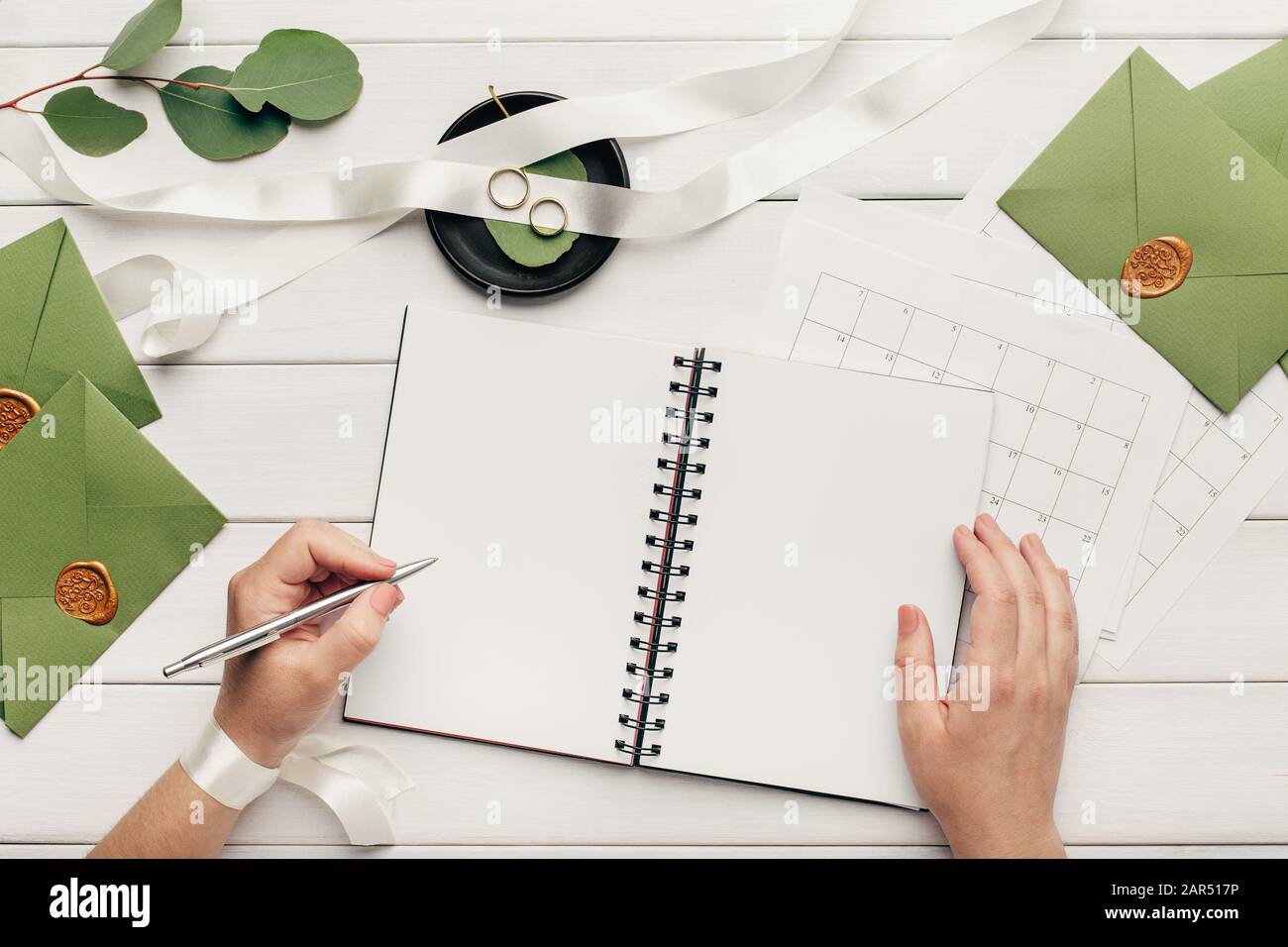 Woman planning wedding and write notes in notepad Stock Photo - Alamy