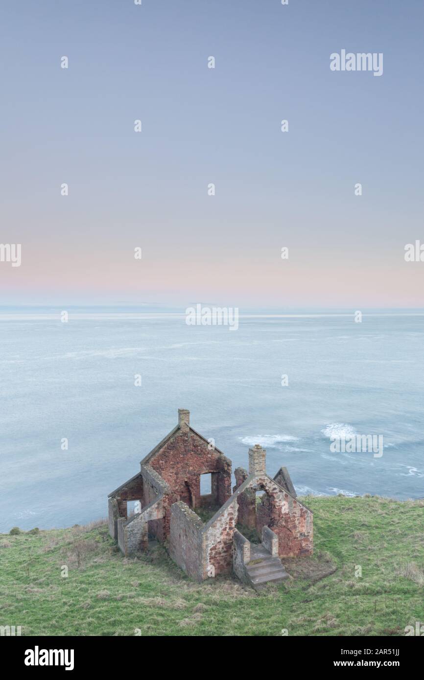 Abandoned stone built bothy overlooking the North Sea on the east coast ...