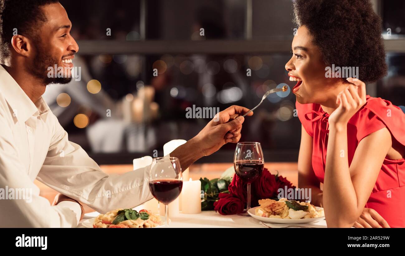 Couple Feeding Each Other Having Romantic Dinner In Restaurant ...