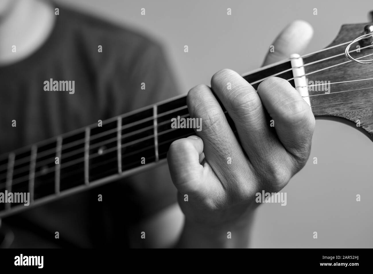 Men catch chords are learning to play guitar. Closeup musicians are ...