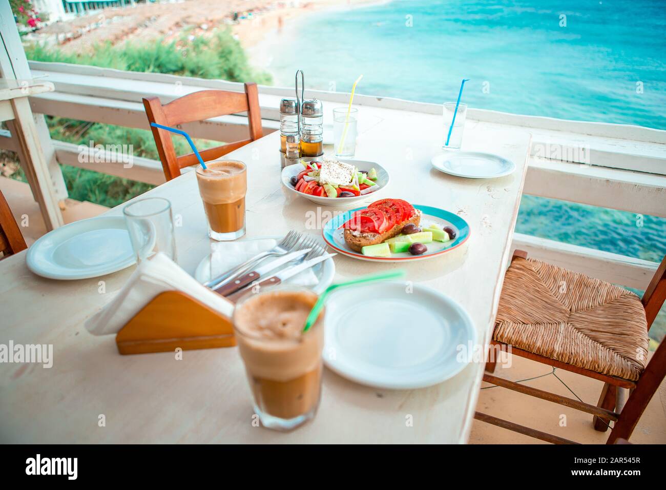 Outdoor cafe on a street of typical greek traditional village in Greece ...
