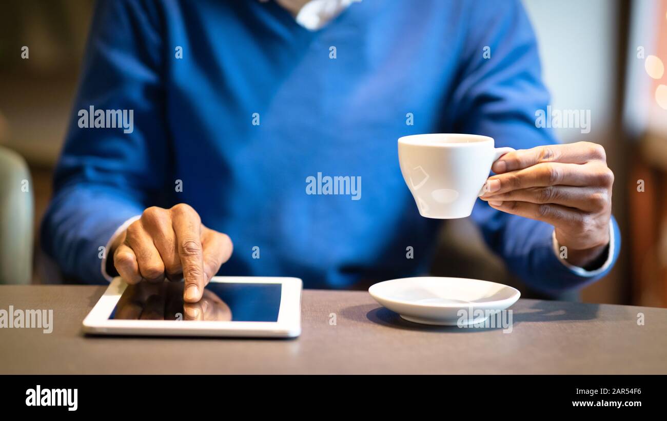 Guy drinking tea in cafe hi-res stock photography and images - Alamy
