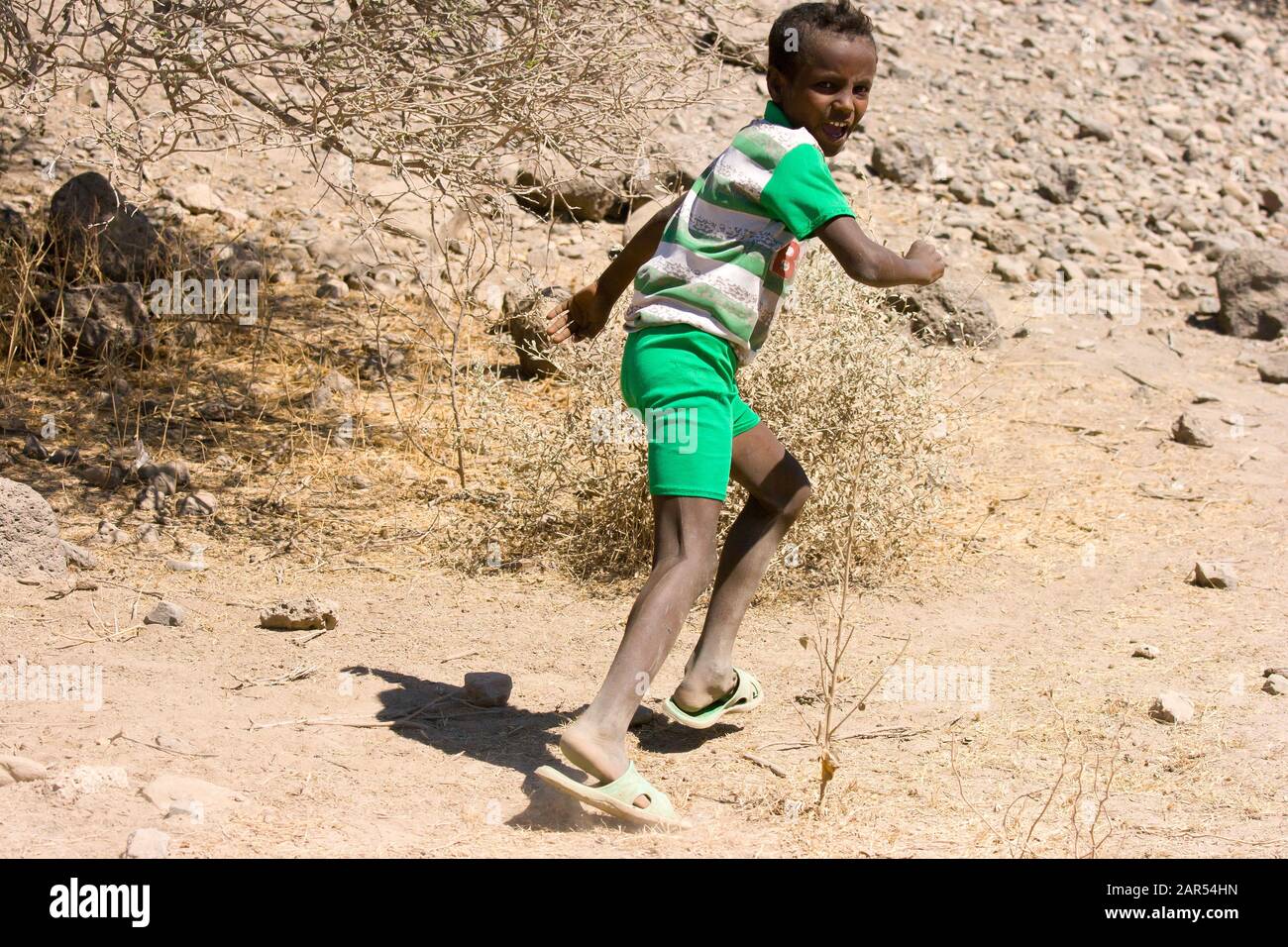 Young Afar boy running and playing, Afar region, Ethiopia. The ...