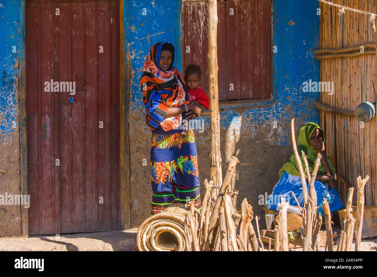 Young Afar women in front of the house, Afar region, Ethiopia. The ...