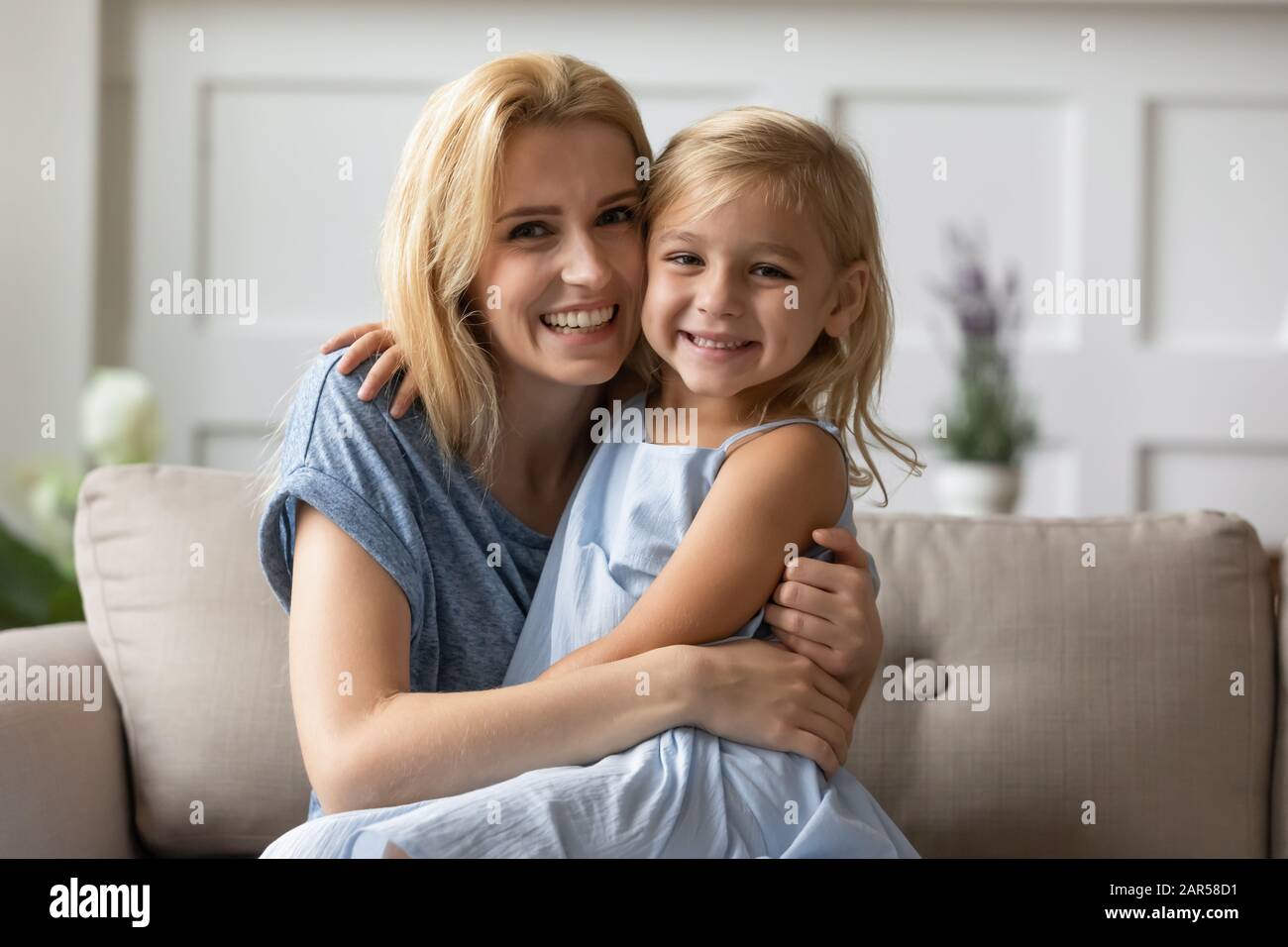 Happy woman babysitter holding on lap cute preschool kid girl Stock ...