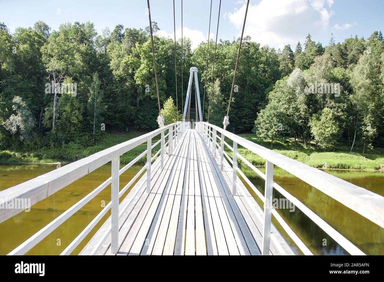 Pedestrian cable bridge over river. The bridge provides scenic views of ...