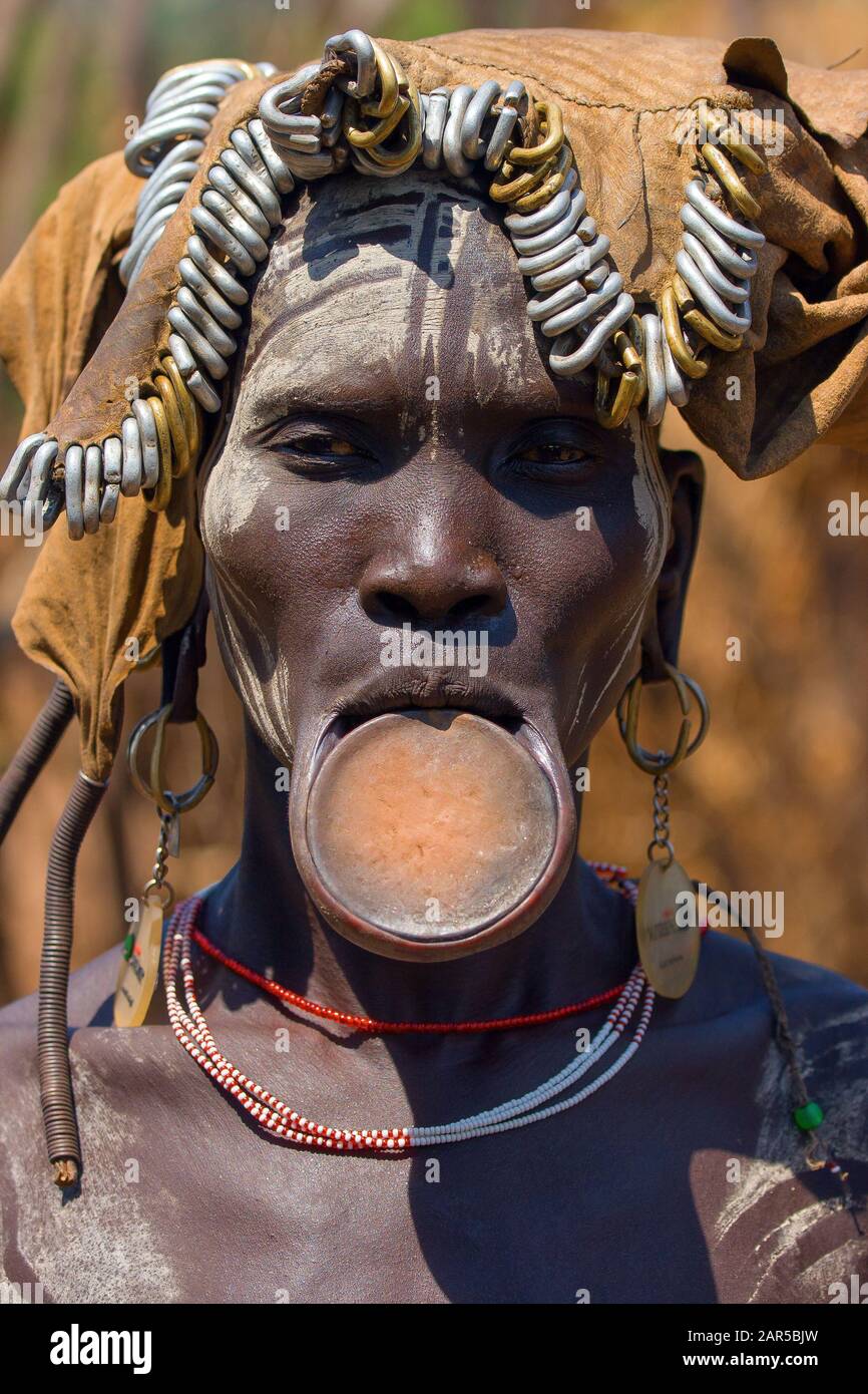 The Mursi women are famous of wearing plates in their lower lips. The ...