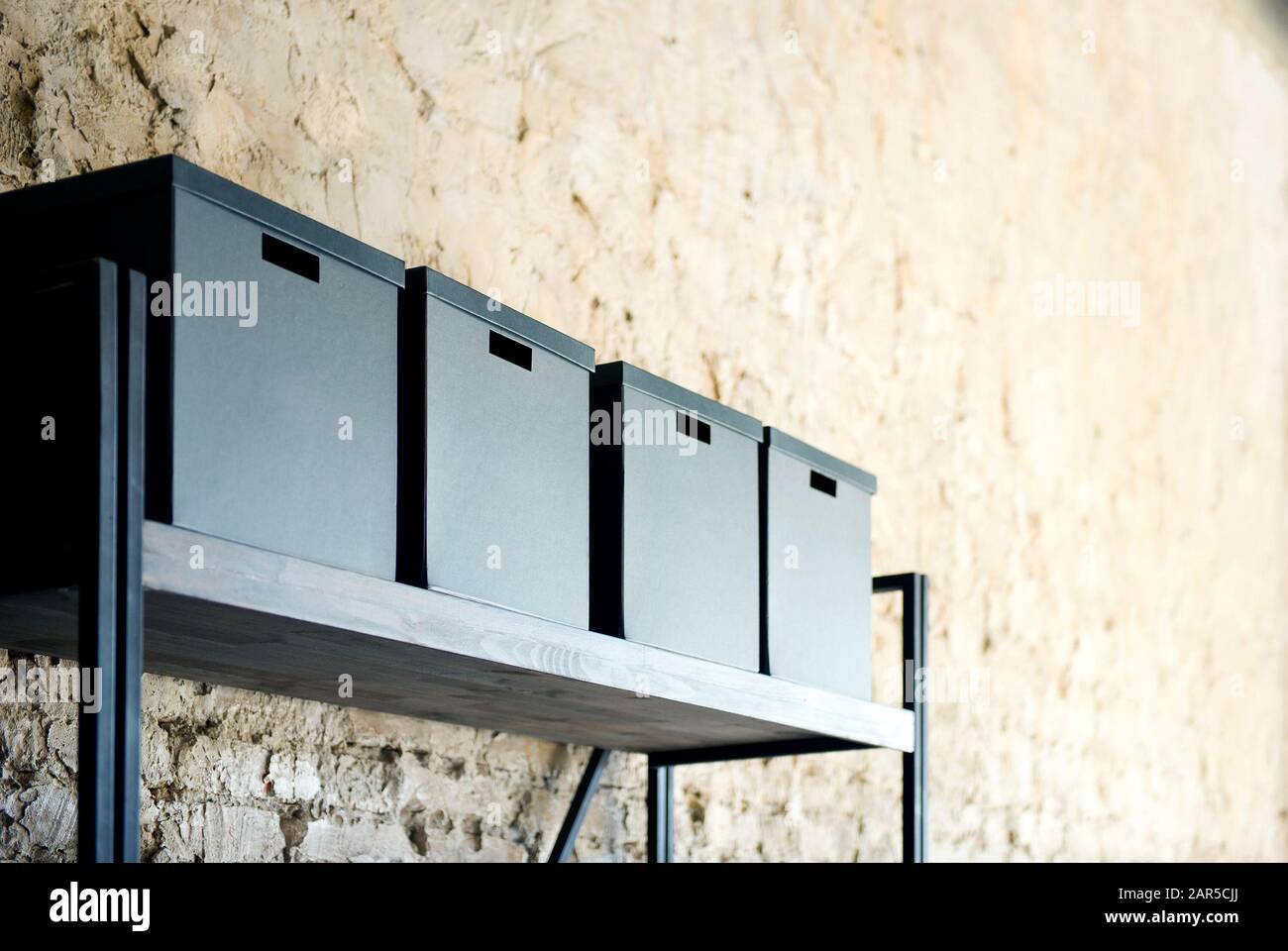 top shelf with four black boxes without signatures Stock Photo - Alamy
