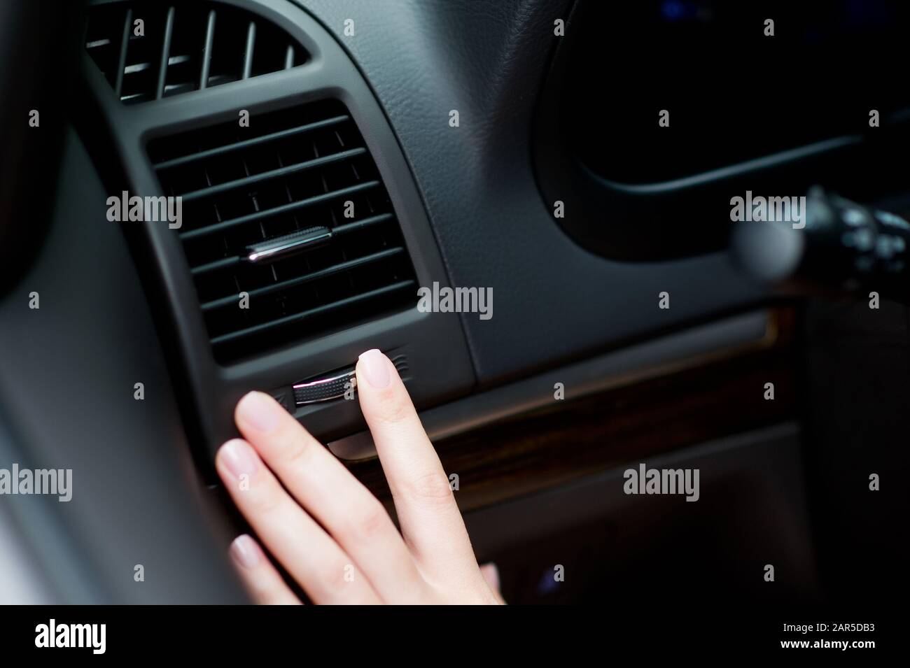 the driver is about to block the air flow from the air conditioner in ...