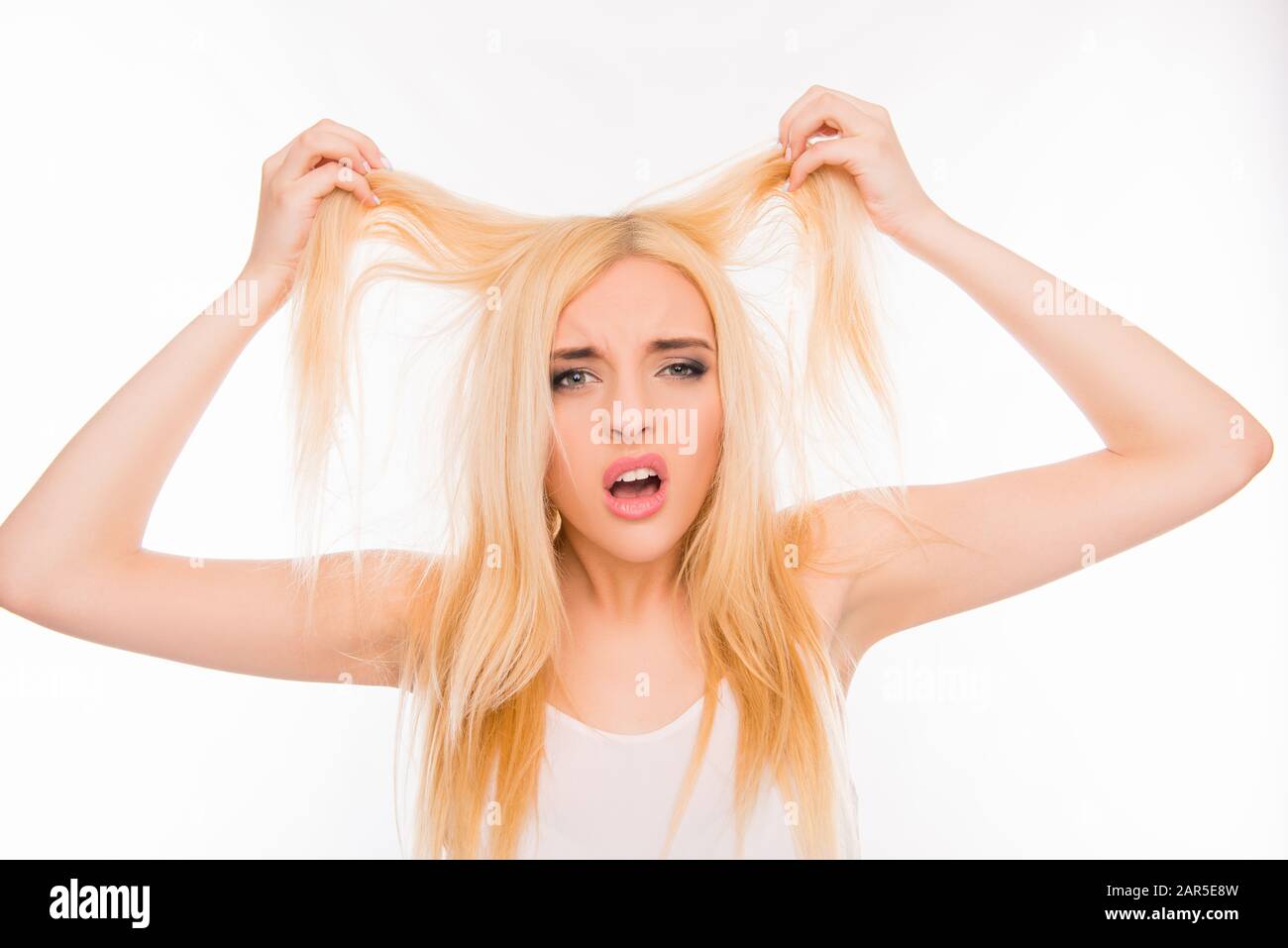 Sad pretty girl showing her damaged hair Stock Photo - Alamy