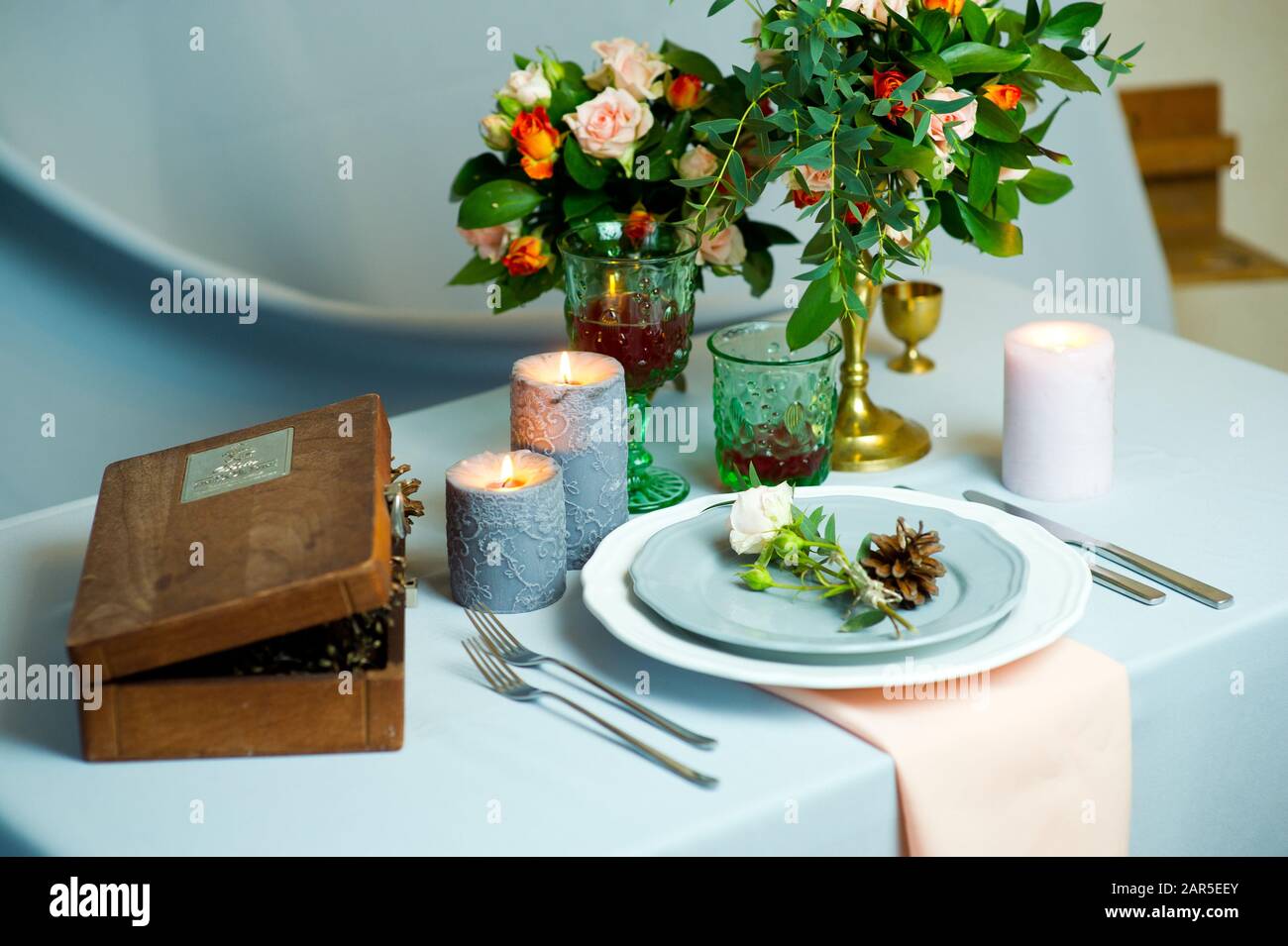 turquoise-colored table with gold plates and cutlery Stock Photo - Alamy