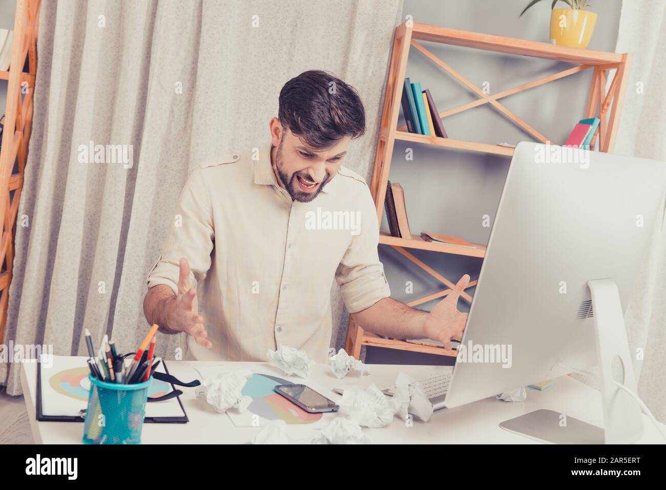 Angry sad man trying to solve difficult task and screaming Stock Photo ...