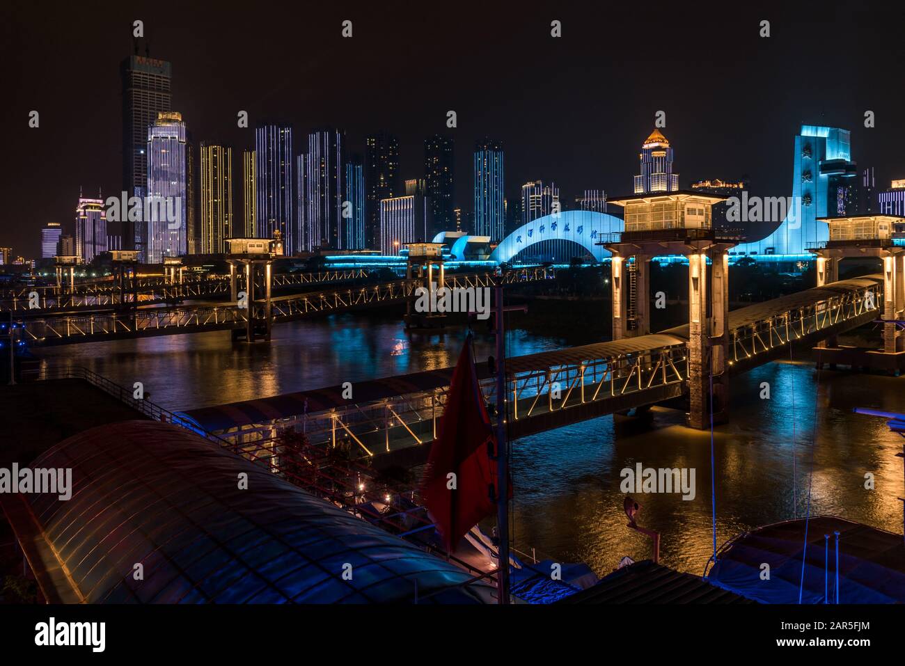Wuhan waterfront at night with illuminated tower blocks forming a ...