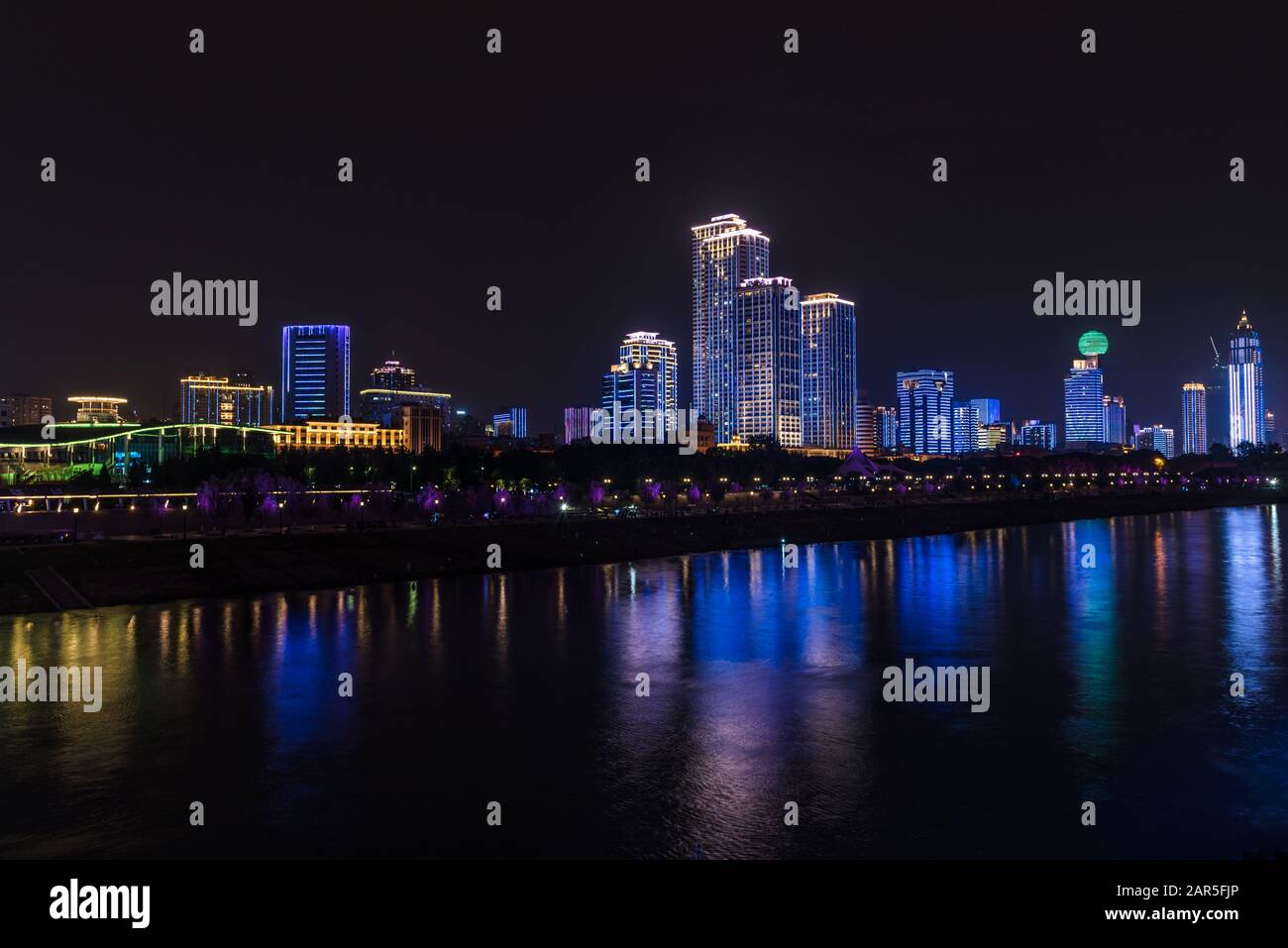 Wuhan waterfront at night with illuminated tower blocks forming a ...