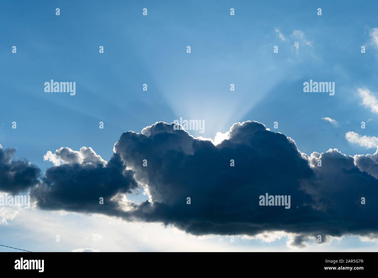 Rays of the sun through the clouds. Clouds and a blue sky with a ...