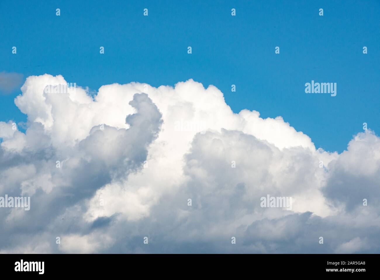 Luminous clouds set against a dark blue sky in the sun. Wonderful blue ...