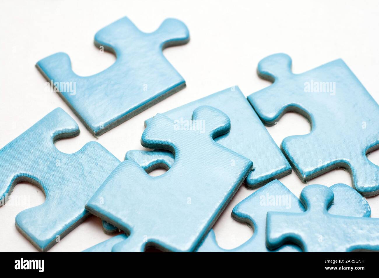 Blue puzzle pieces on white background Stock Photo - Alamy