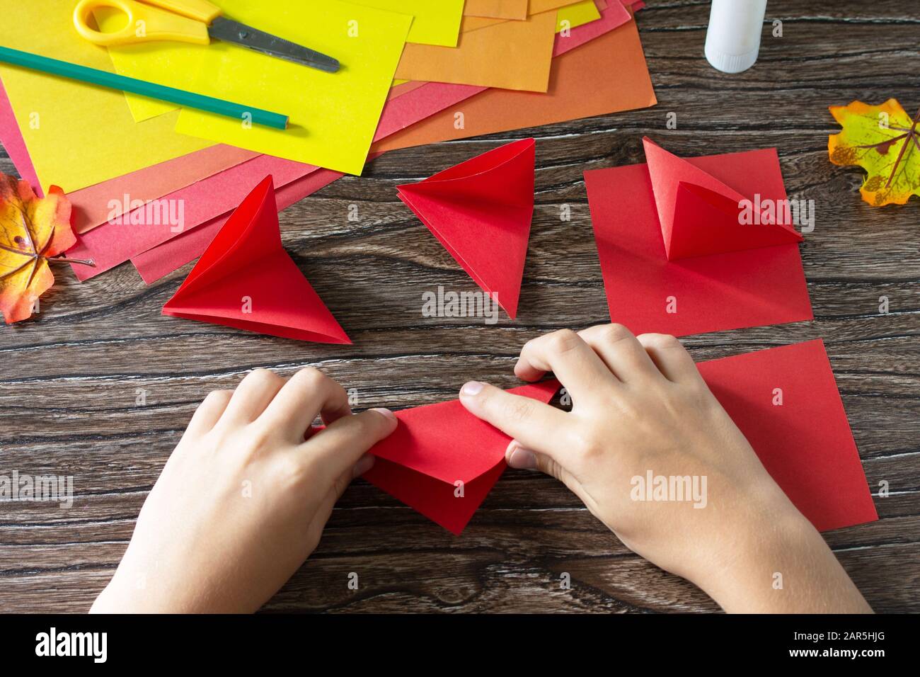 The child collect paper leaves. Colored paper leaves in autumn on ...