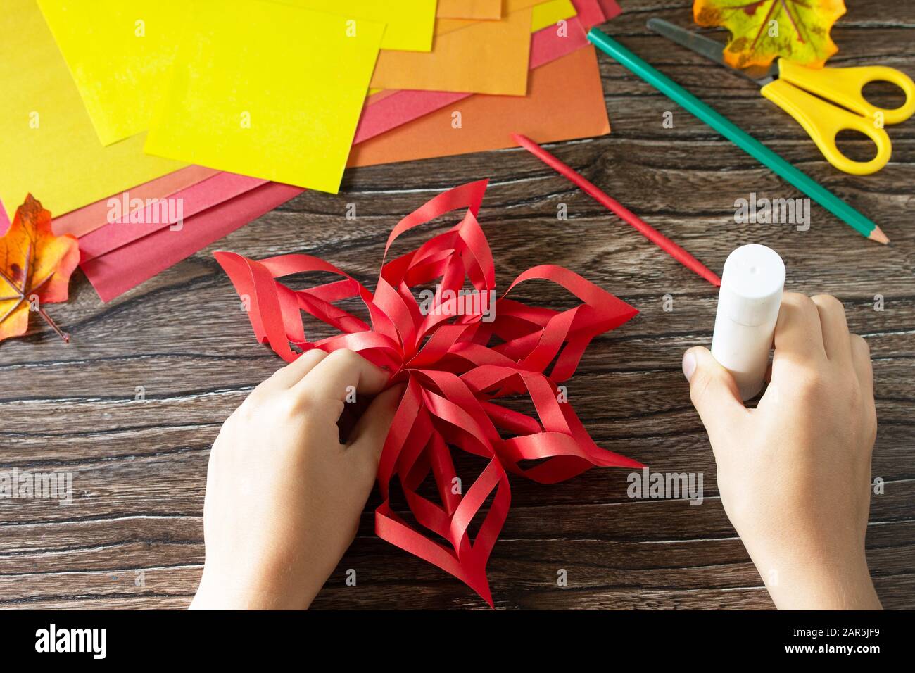 The child collect paper leaves. Colored paper leaves in autumn on ...