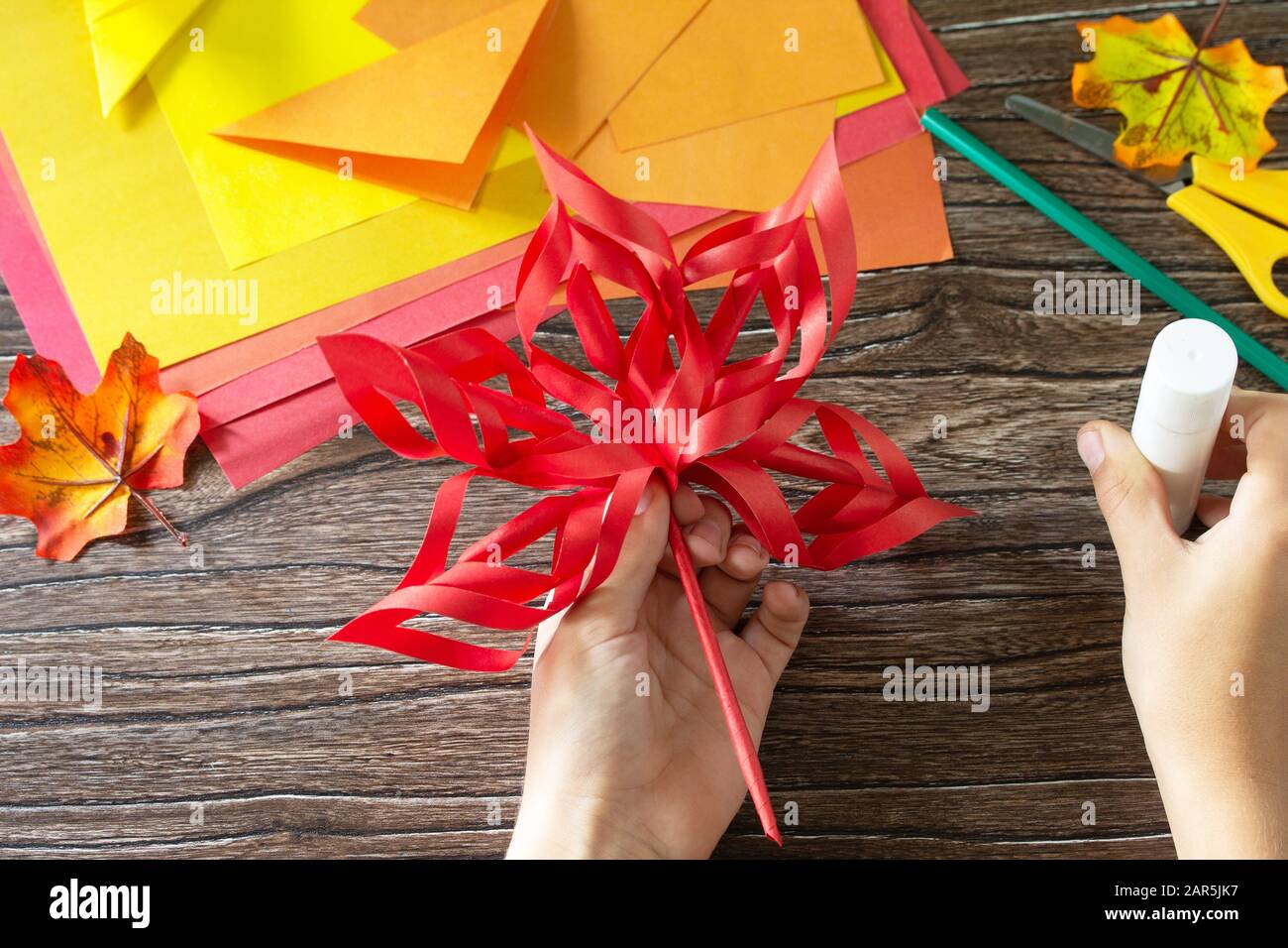 The child collect paper leaves. Colored paper leaves in autumn on ...