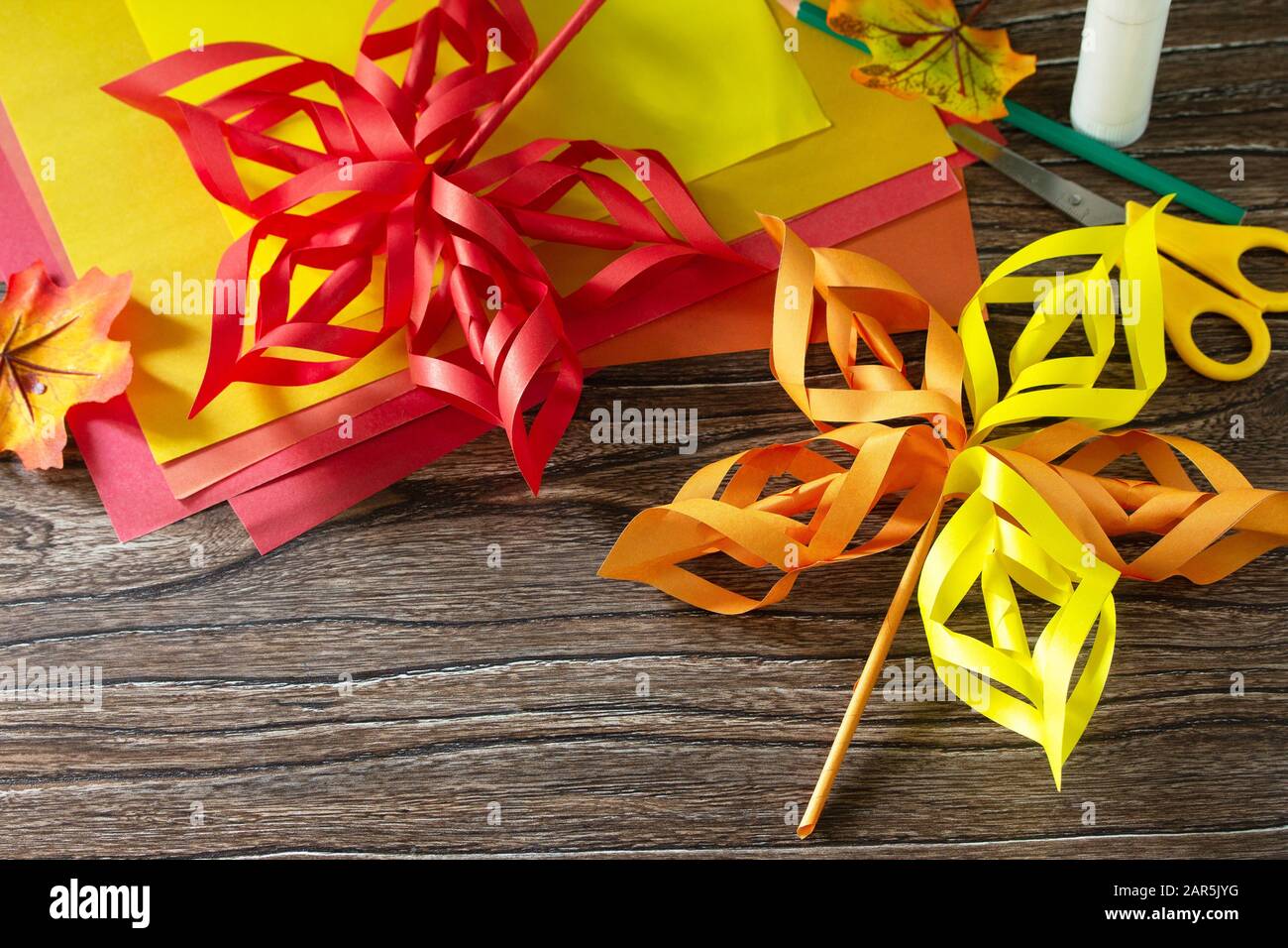 Colored paper leaves in autumn on wooden background. Crafts from paper ...