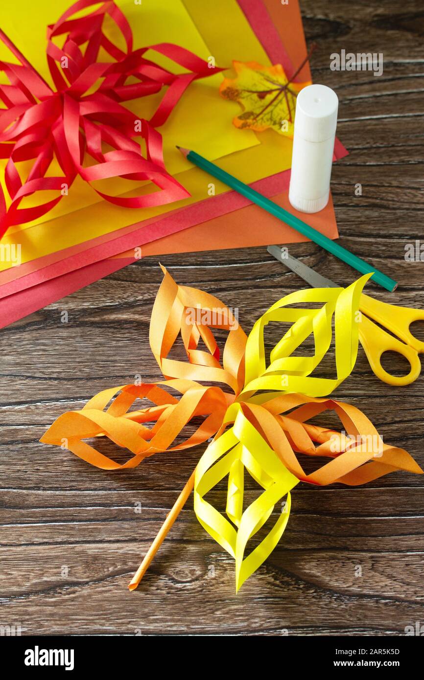 Colored paper leaves in autumn on wooden background. Crafts from paper ...