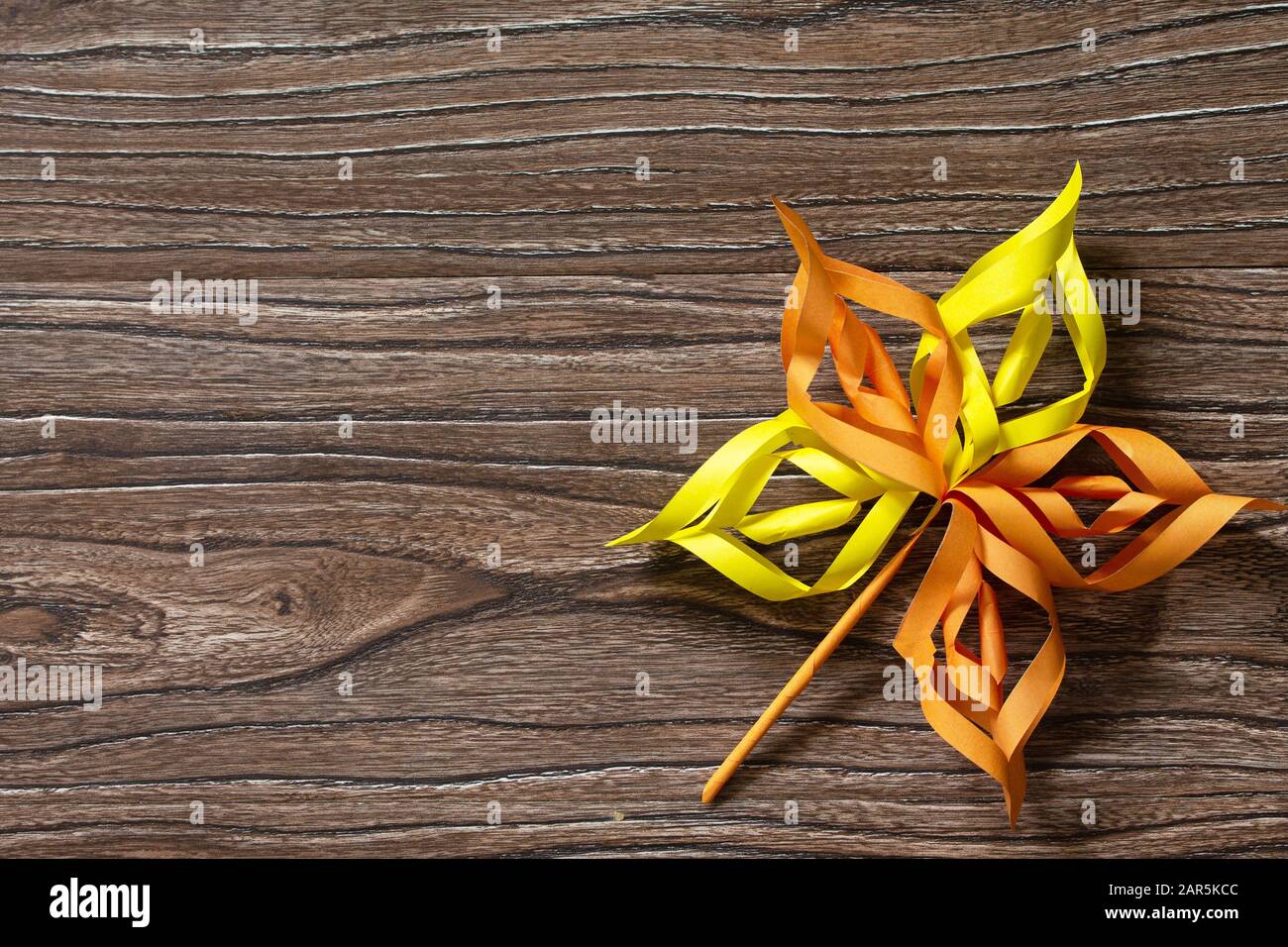 Autumn decor. Colored paper leaves in autumn on wooden background ...