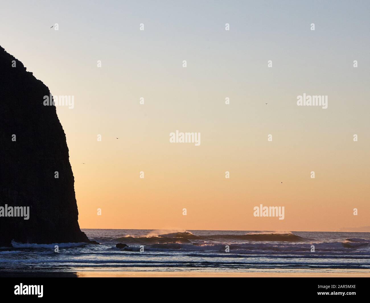 Famous Haystack Rock on the rocky shoreline of the Pacific Ocean Stock ...