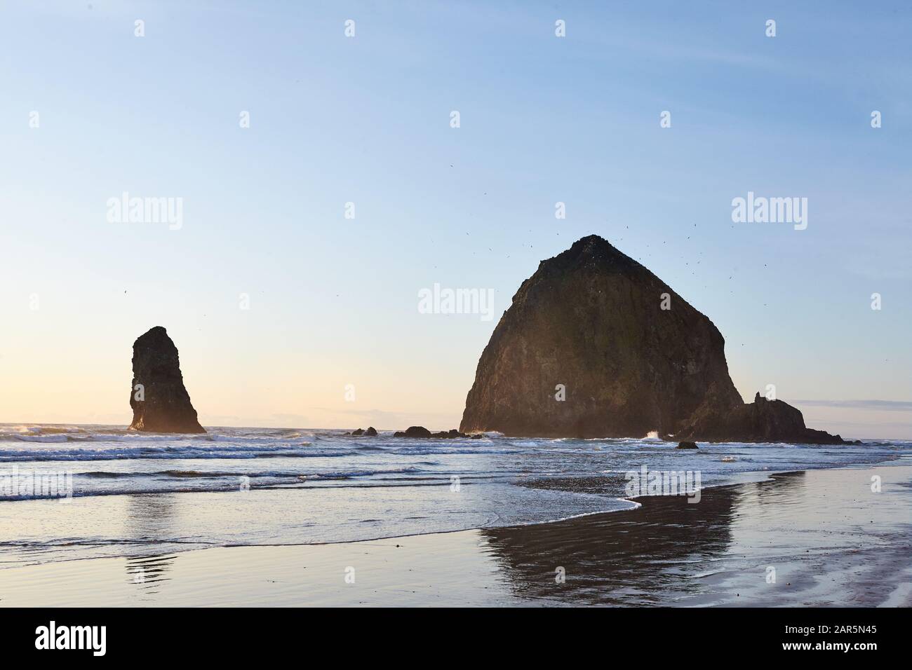 Famous Haystack Rock on the rocky shoreline of the Pacific Ocean Stock ...