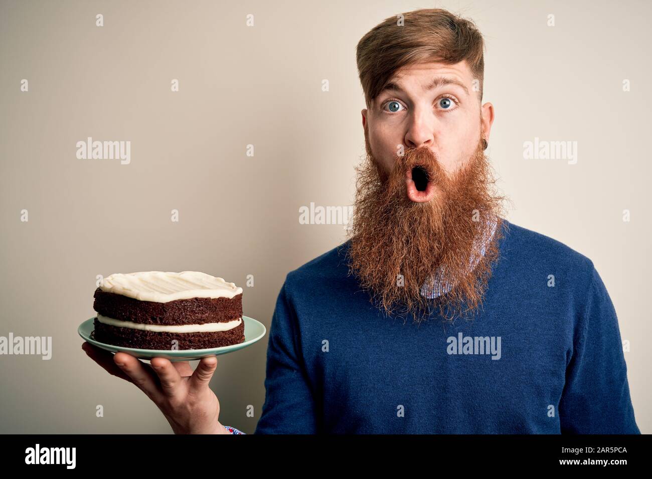 Irish redhead man with beard holding birthday cake with decorations ...