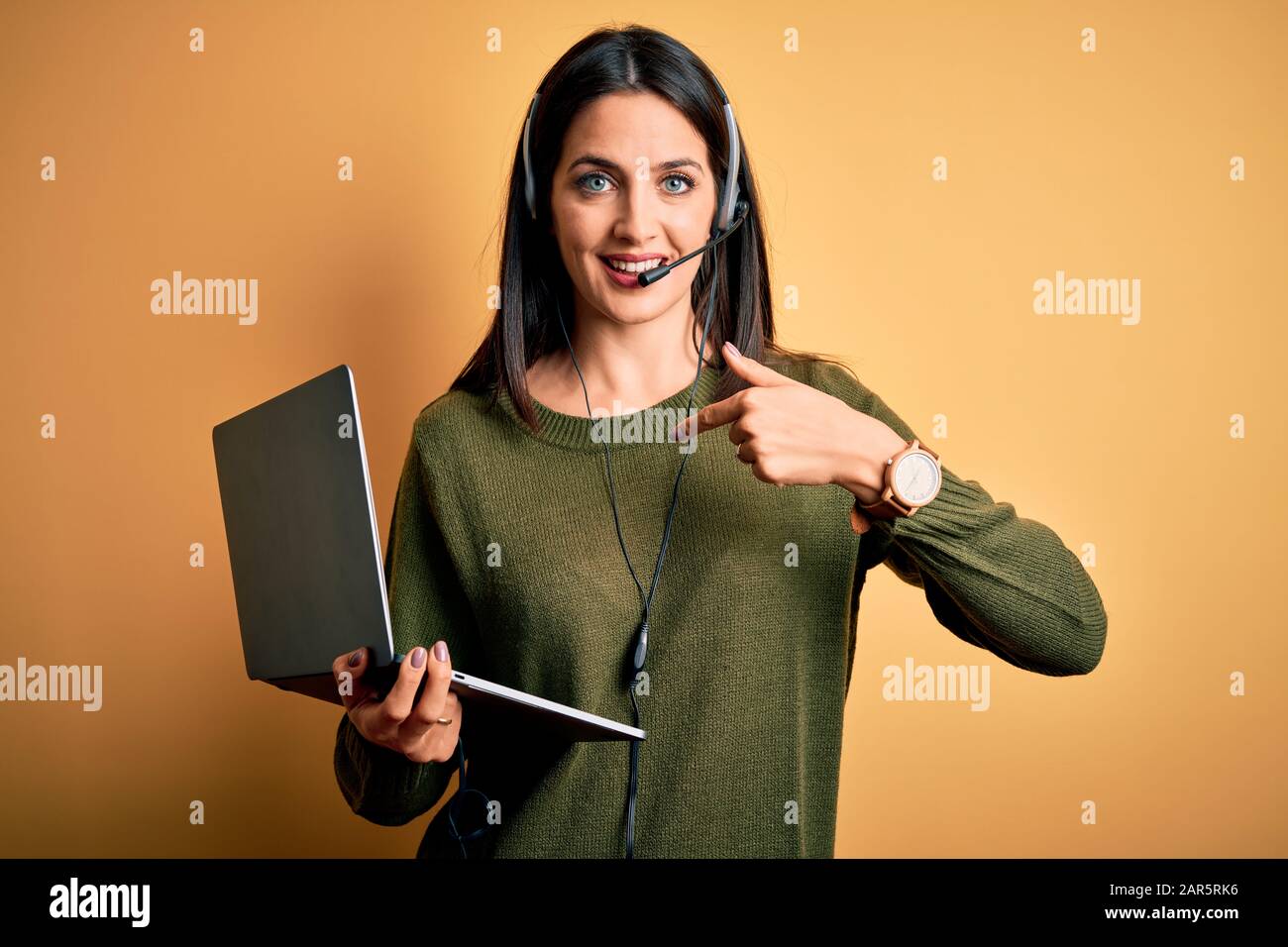 Young operator woman with blue eyes working on call center using ...