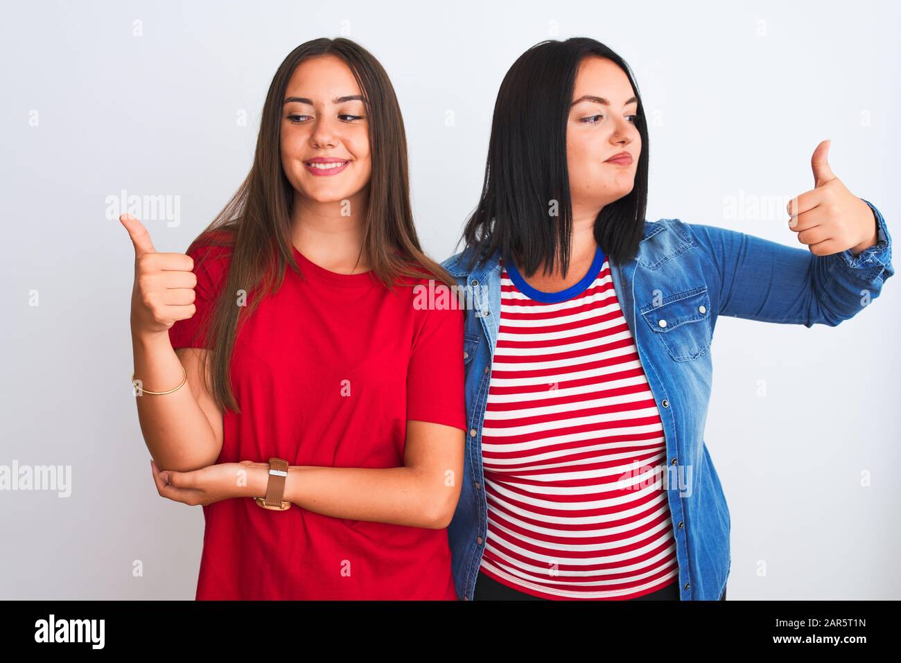 Young beautiful women wearing casual clothes standing over isolated ...