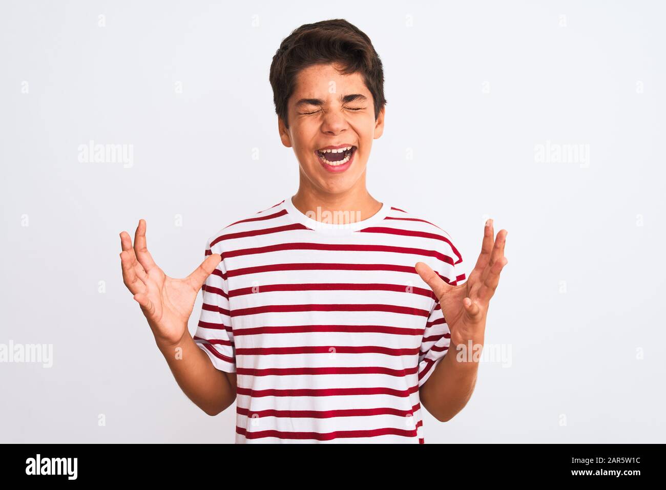 Handsome teenager boy standing over white isolated background ...