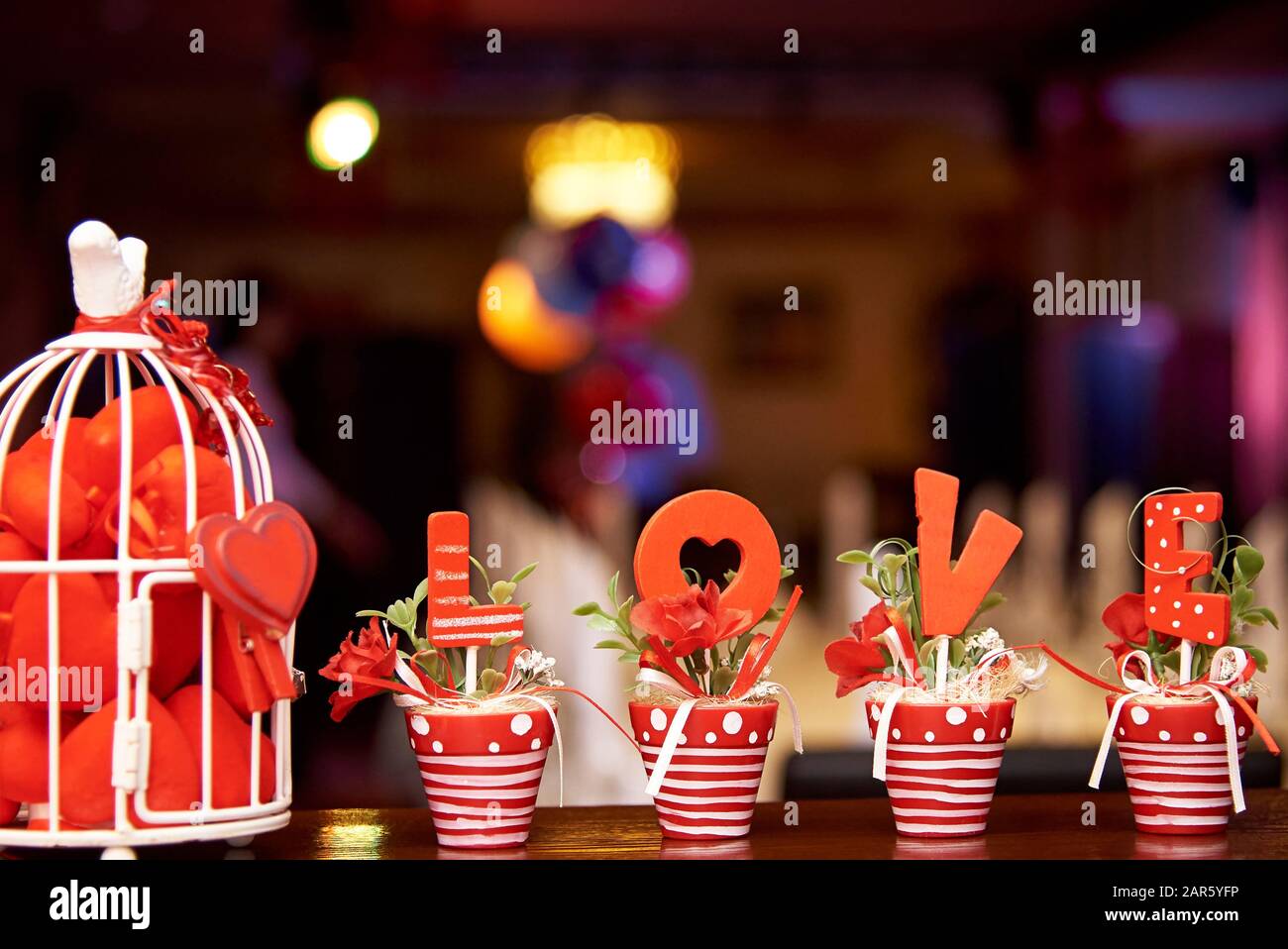 Love letters in flower pots on blurred background Stock Photo - Alamy
