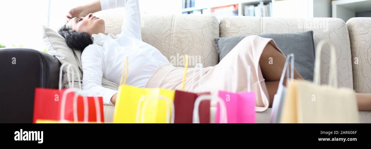 Tired woman after shopping Stock Photo - Alamy