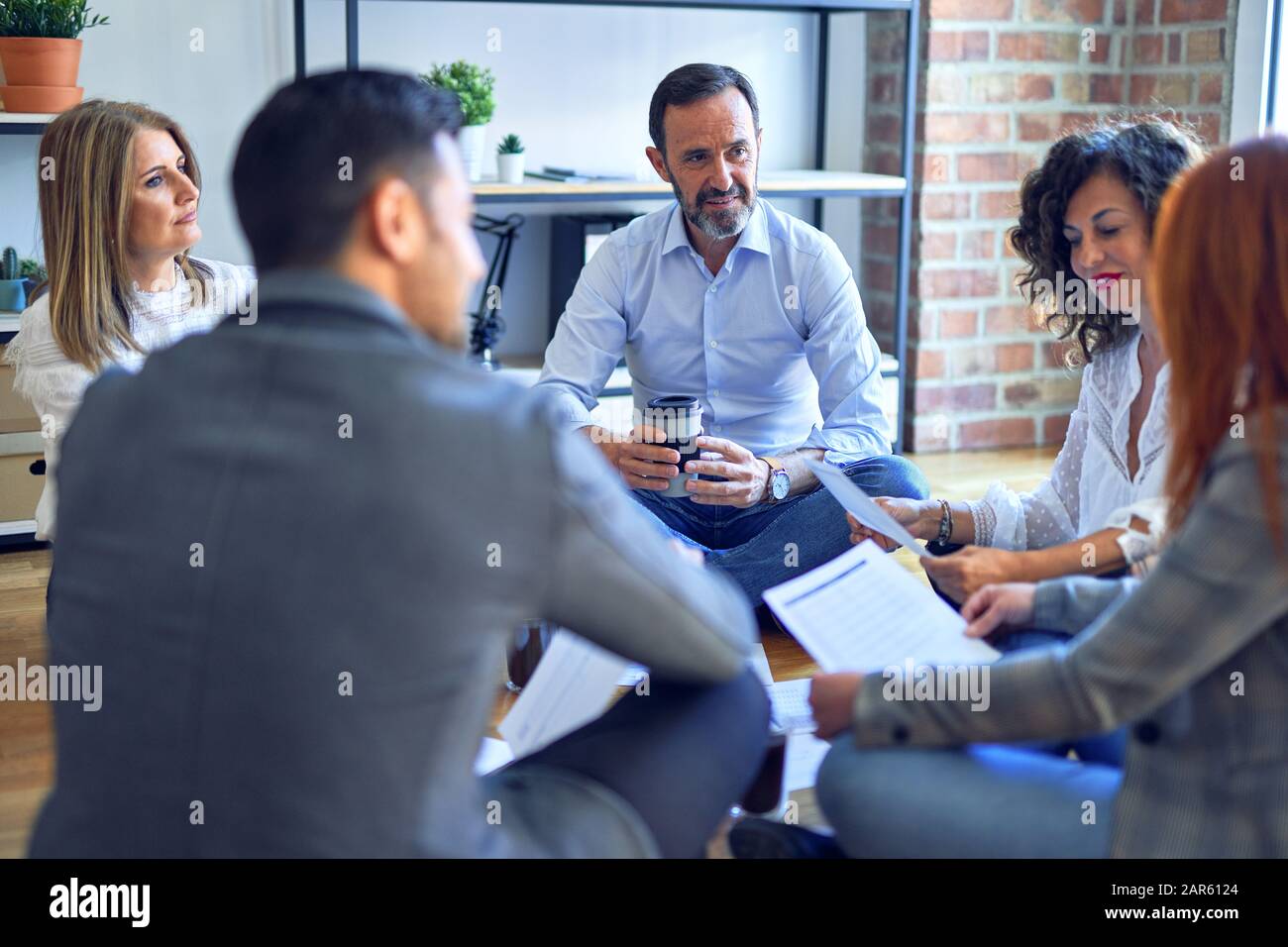 Group of business workers smiling happy and confident. Sitting on the ...