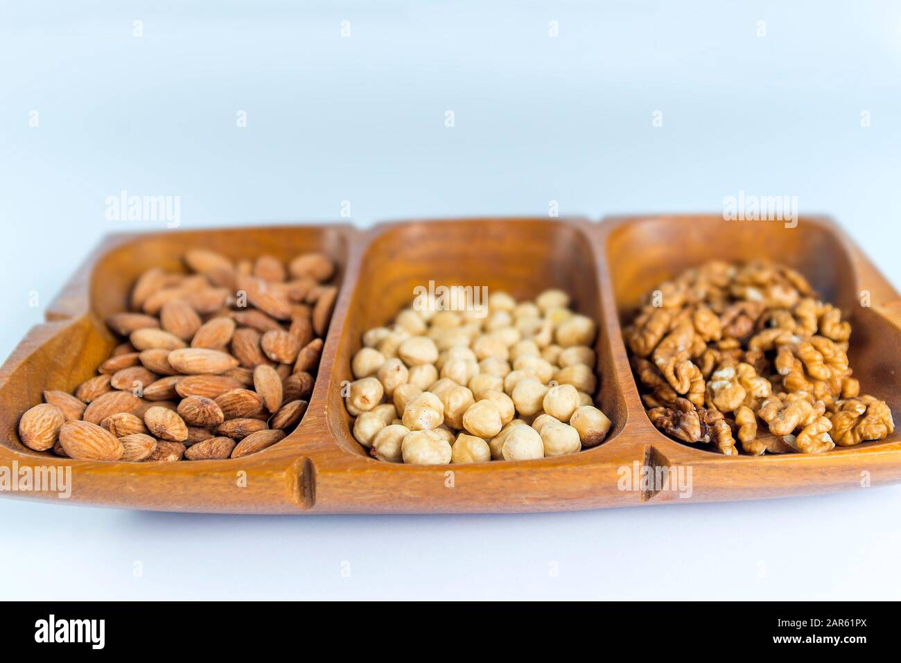 Close-up of healthy raw snack of nuts served in a wooden container ...