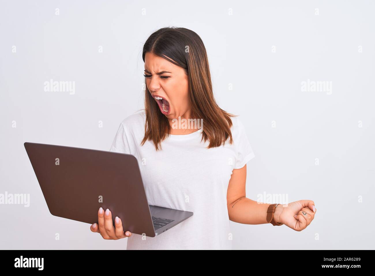 Beautiful young woman working using computer laptop over white ...