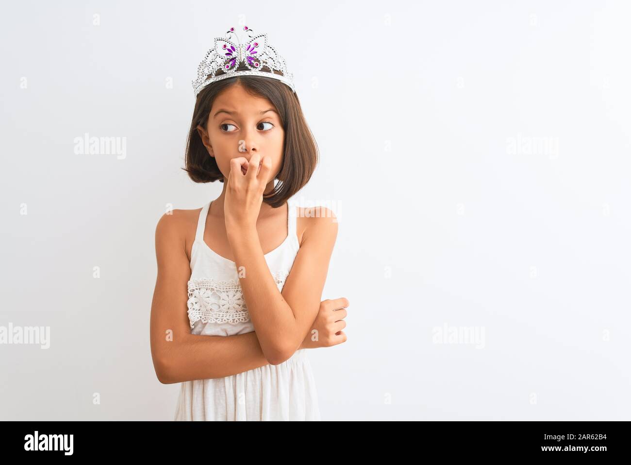 Beautiful child girl wearing princess crown standing over isolated ...
