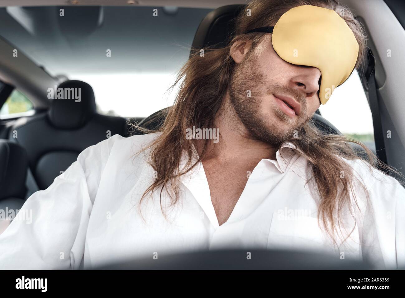 Mode of Transport. Man with long hair in sleeping mask traveling ...