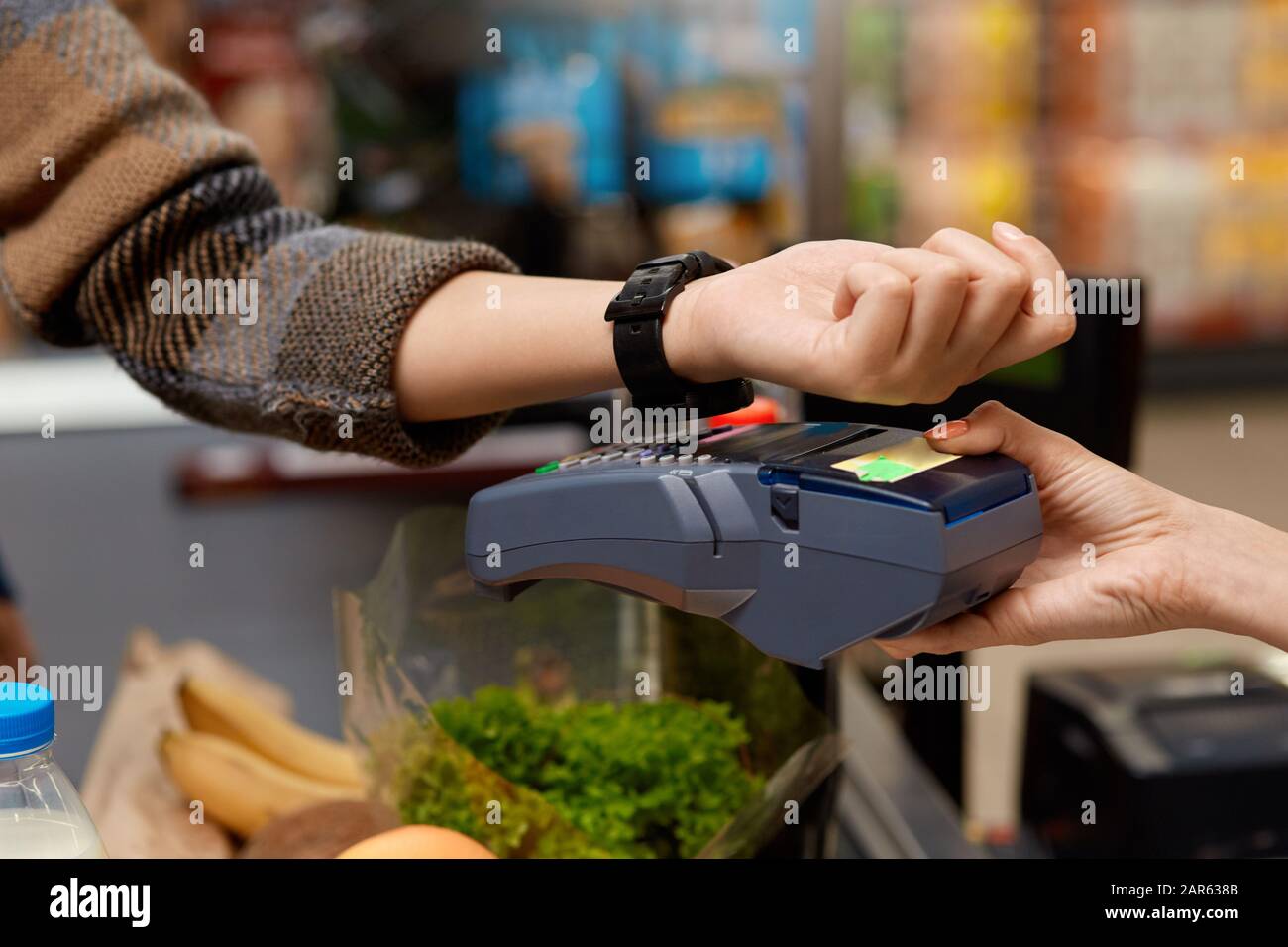 Daily Shopping. Woman standing at the supermarket cashier counter ...