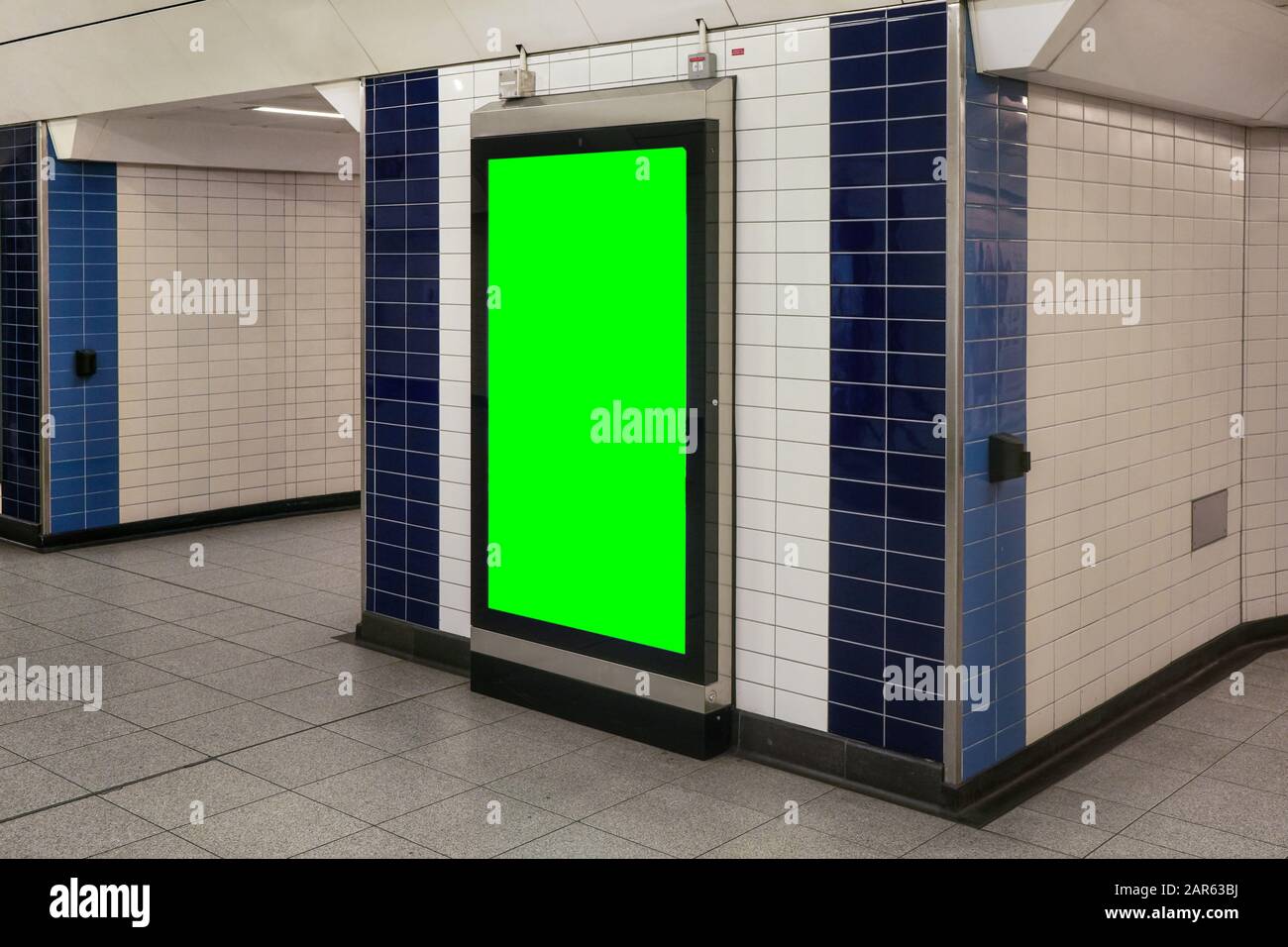 Advertising board display green mockup on wall with white tiles at ...