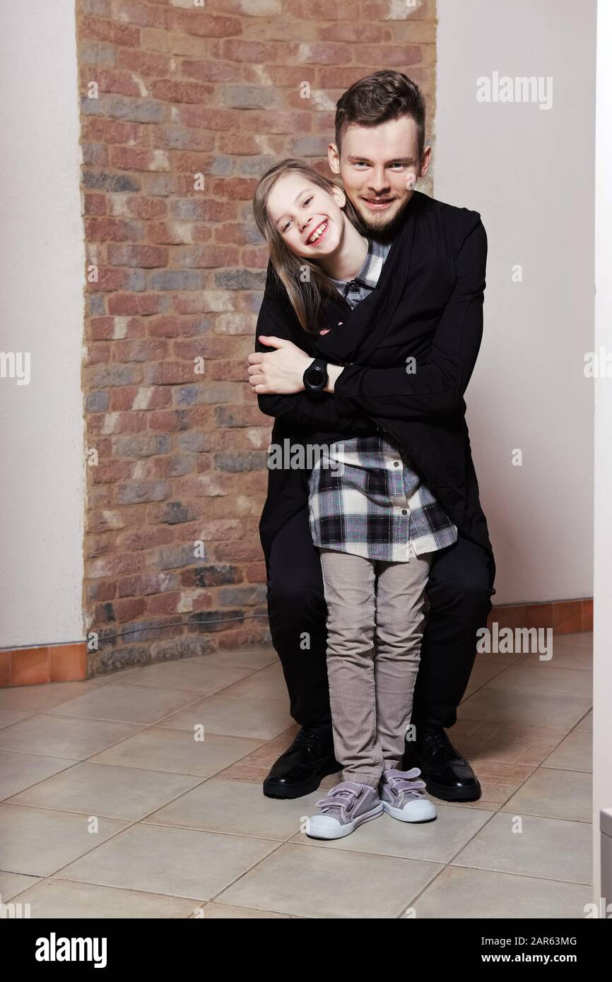 Portrait of happy family giving a hug Stock Photo - Alamy