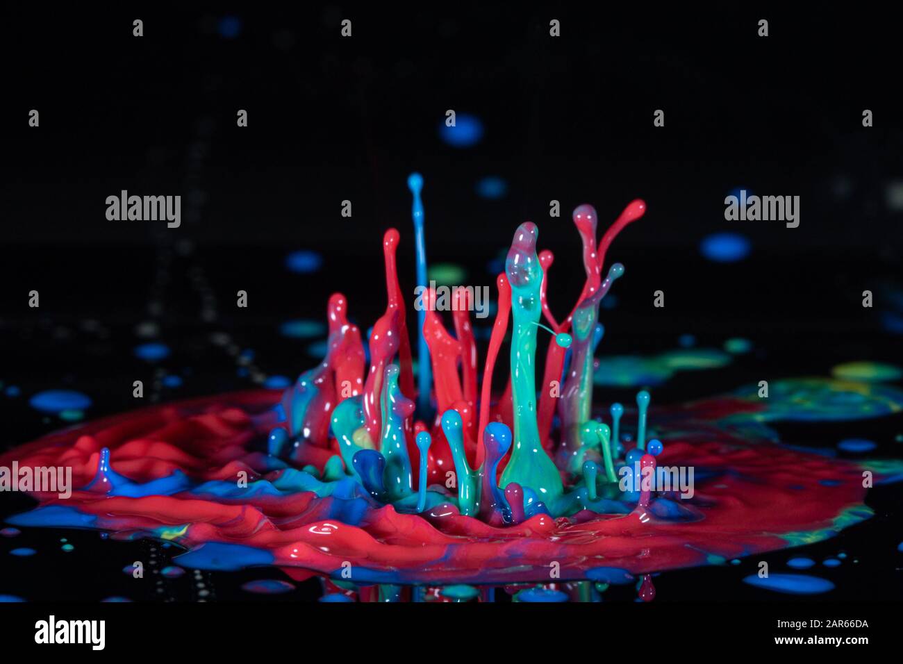 Color ink splash on a black background Stock Photo - Alamy